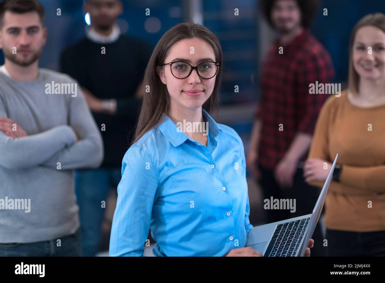 Portrait of successful creative business team looking at camera and ...