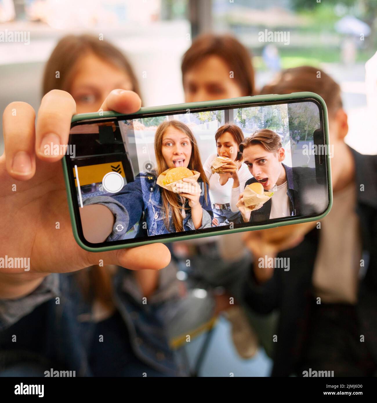 Group friends taking selfie together while eating fast food Stock Photo ...