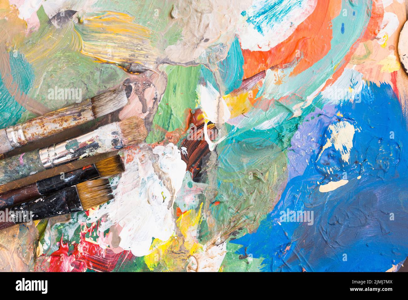 Elevated view paint brushes colorful messy background Stock Photo - Alamy