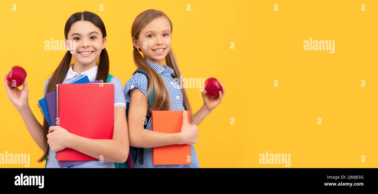 School girls friends. Happy pupils with books hold vitamin organic ...