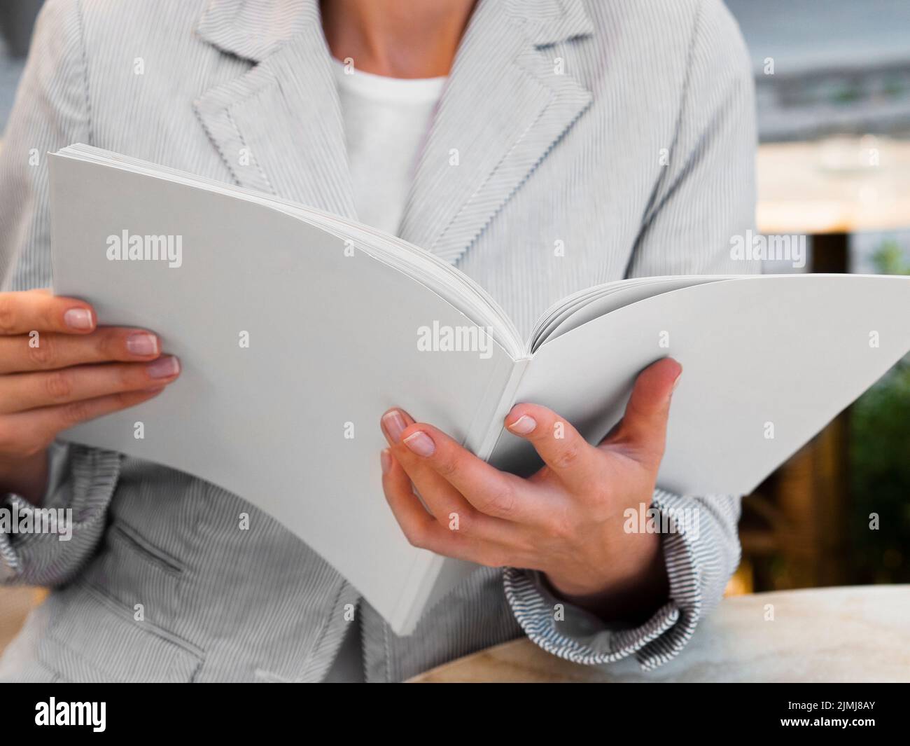 Close up woman reading mock up magazine Stock Photo - Alamy
