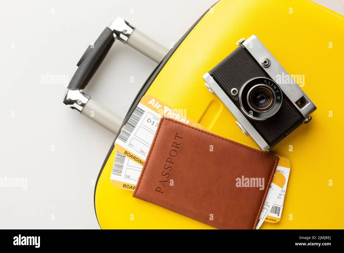 Yellow luggage with camera passport Stock Photo - Alamy