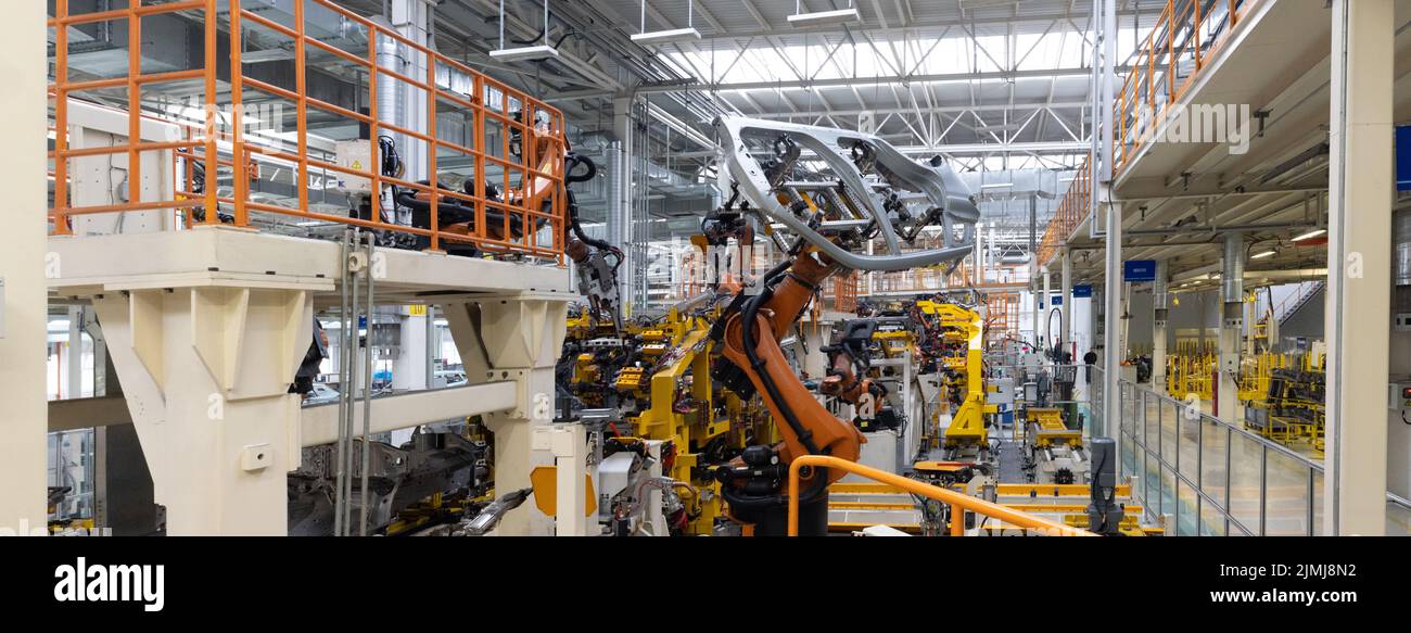 Panoramic photo of automobile production line. Welding car body. Modern ...