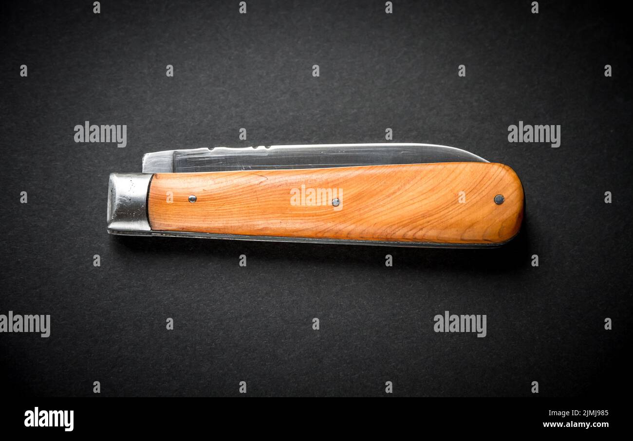 Traditional wooden pocket knife on black background Stock Photo - Alamy