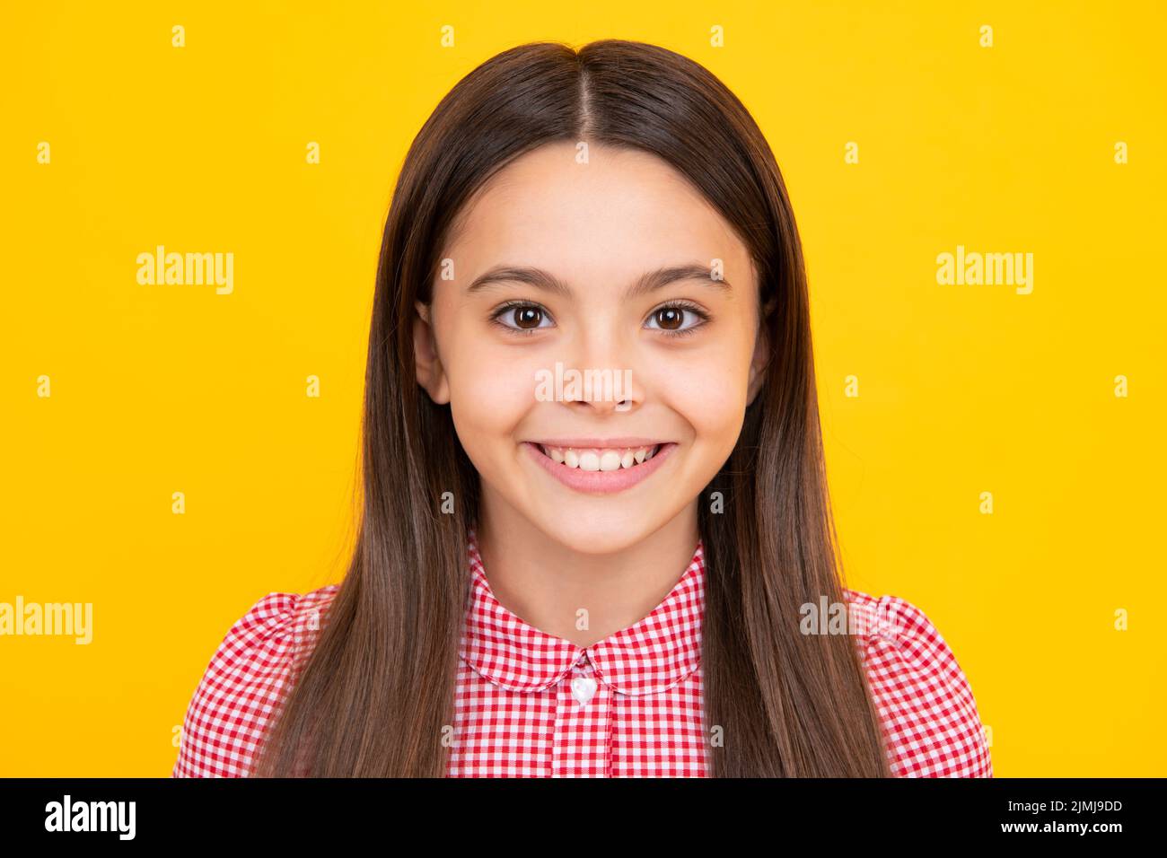 Portrait of cute positive little girl isolated on yellow background ...