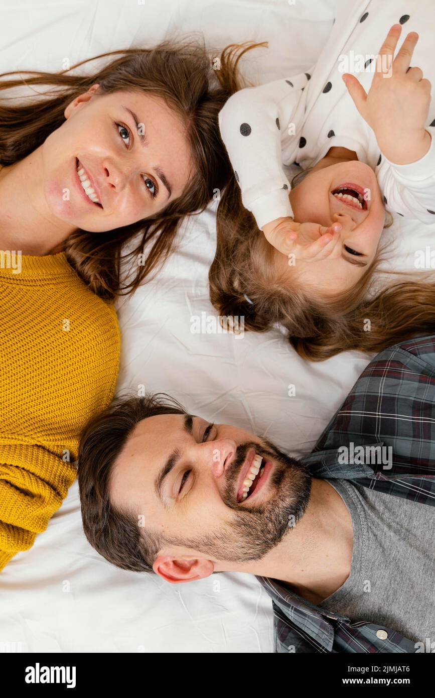Close up smiley family bed Stock Photo - Alamy