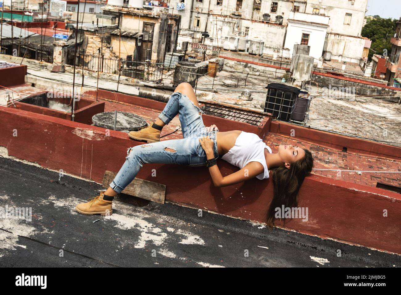 Woman on the roof of old building in Havana Stock Photo - Alamy