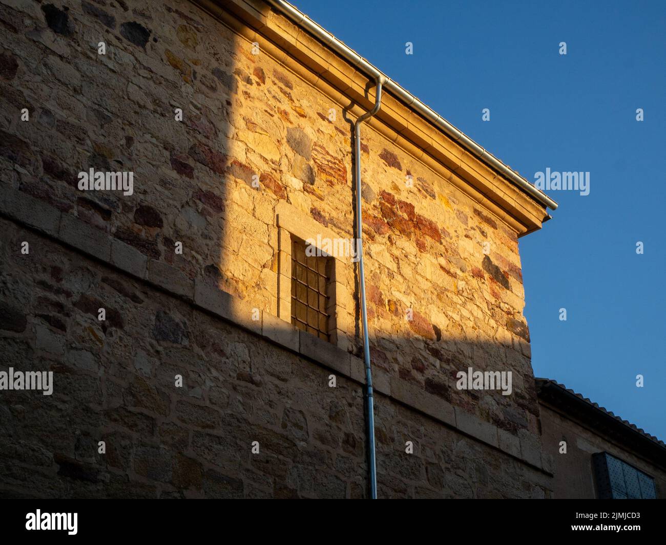 stone wall at sunset. Concept of sustainable architecture Stock Photo ...