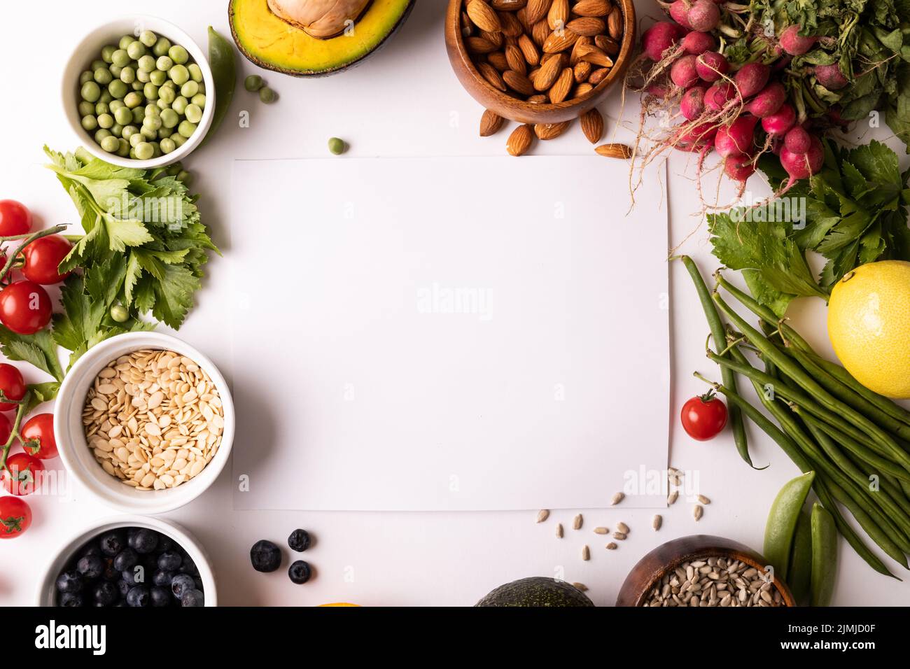 Overhead view of copy space amidst various fresh food on white ...