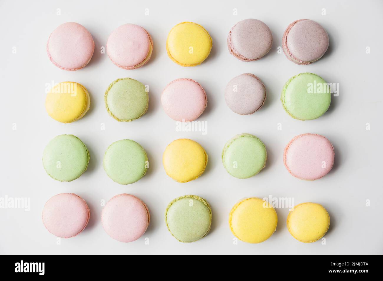 Row macaroons white backdrop Stock Photo - Alamy