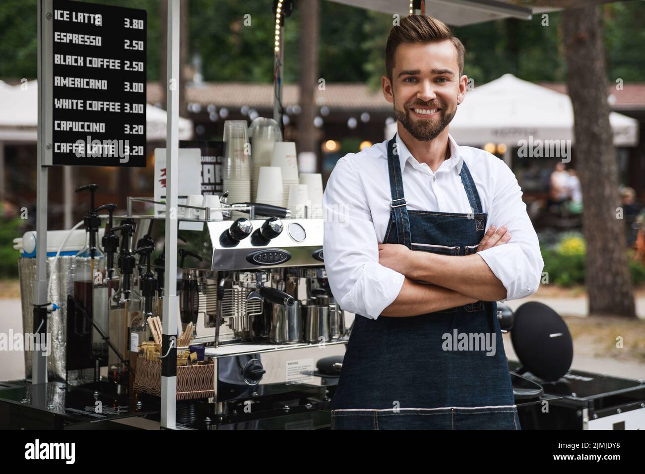Handsome barista man during work in his street coffee shop Stock Photo ...