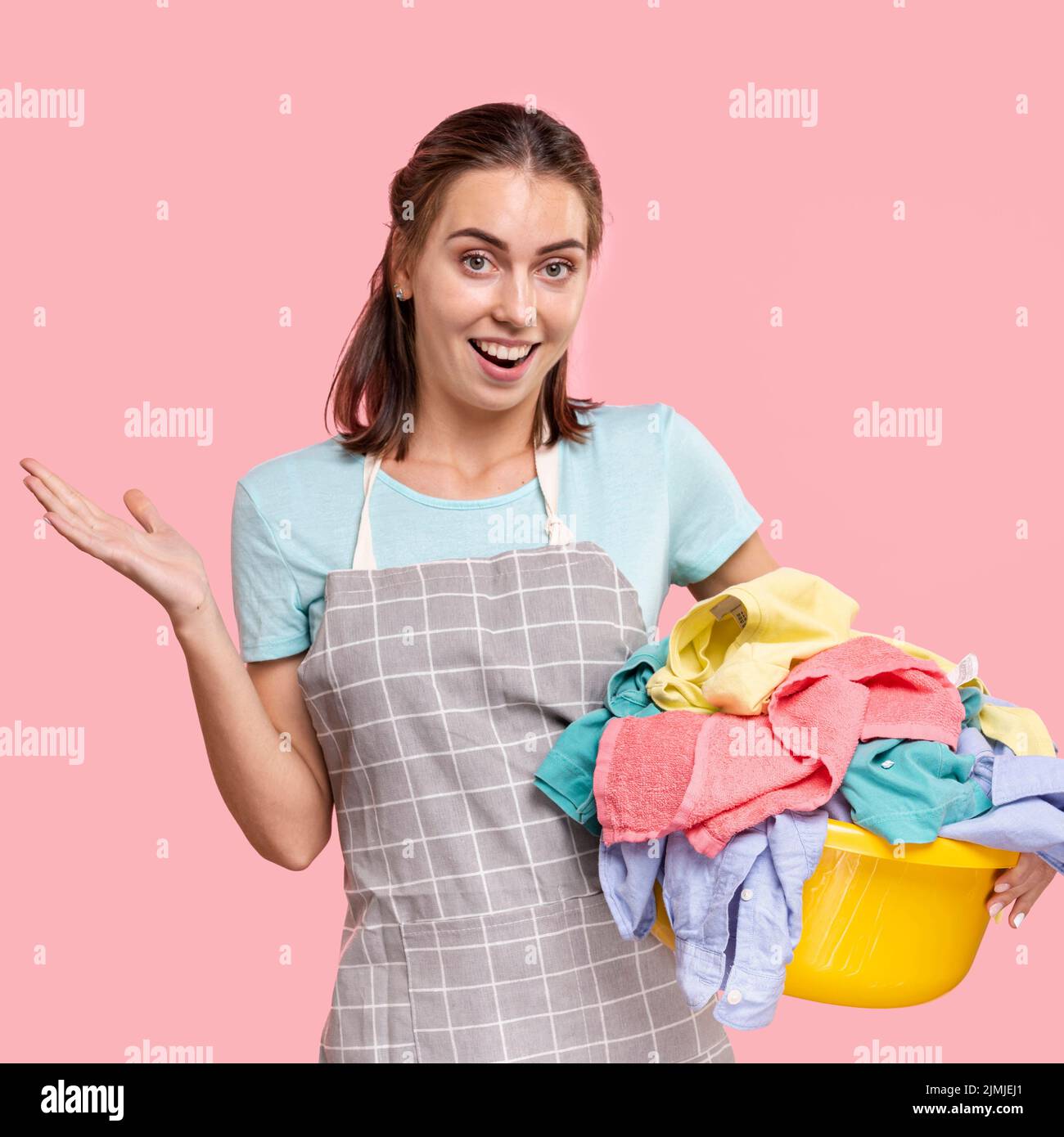 Medium shot smiley woman with apron Stock Photo - Alamy