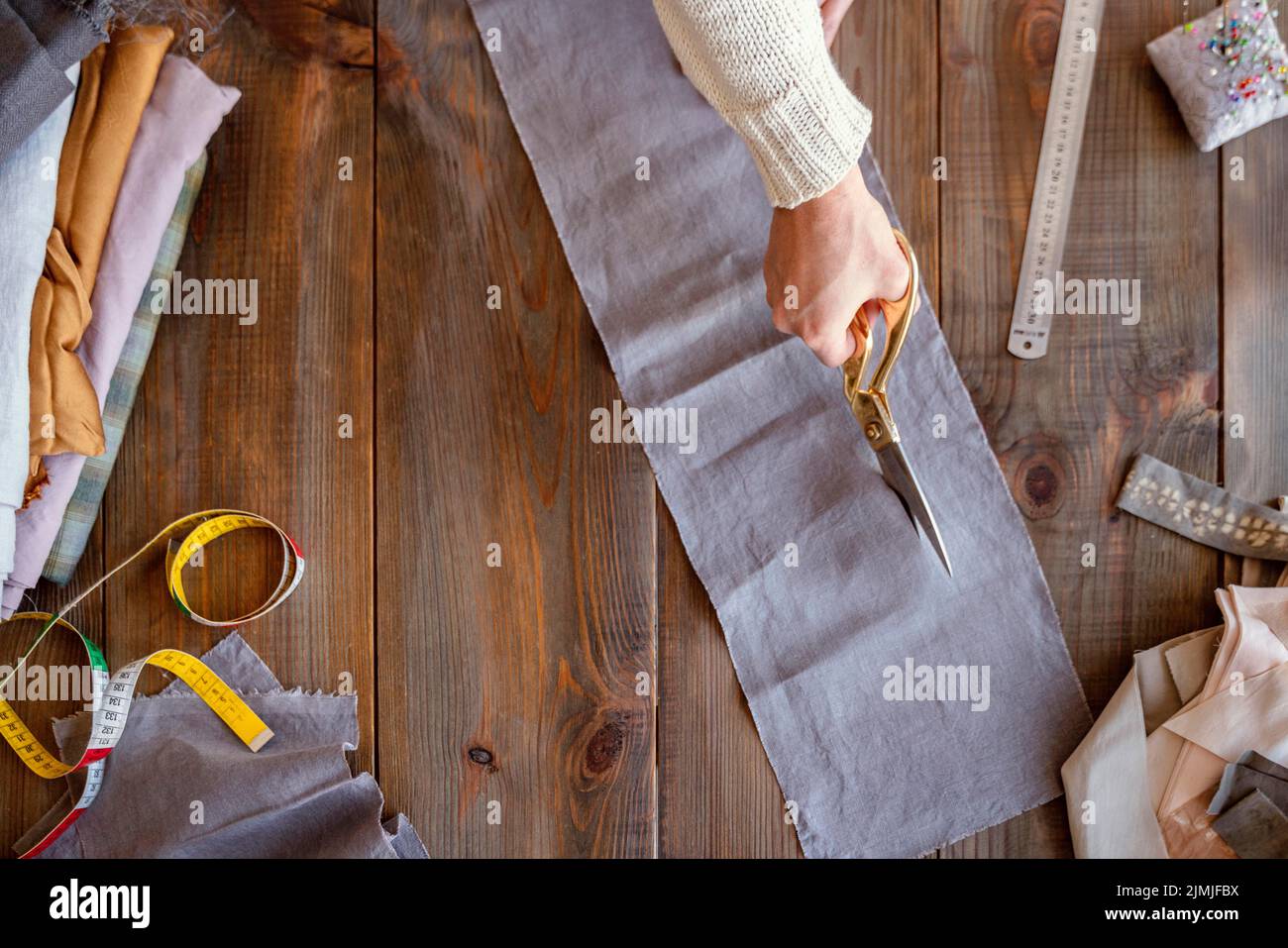 Person cutting fabric sewing Stock Photo - Alamy