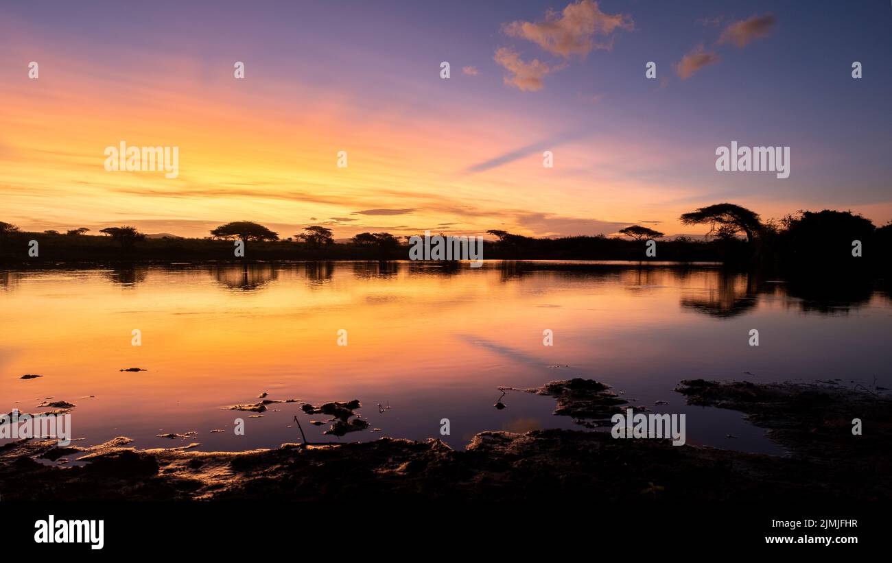 Sunset by a water pool lake in the Savannah of South Africa Kwazulu ...