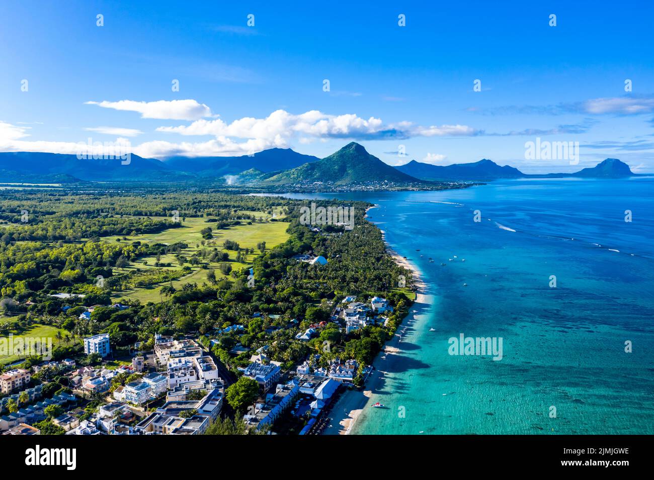 The beach at Flic en Flac with luxury hotels and palm trees, behind the ...