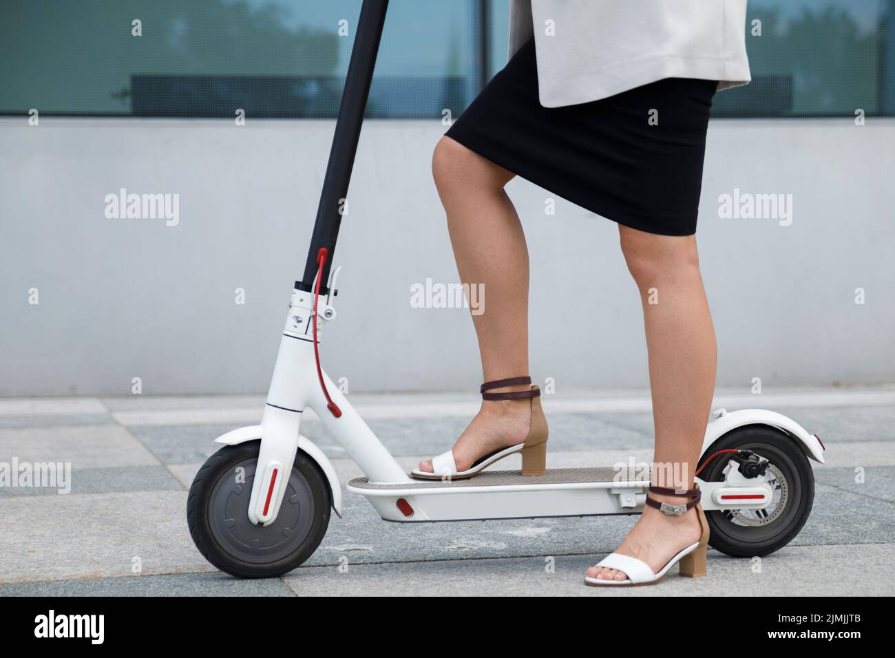 Female legs on the electric scooter Stock Photo - Alamy