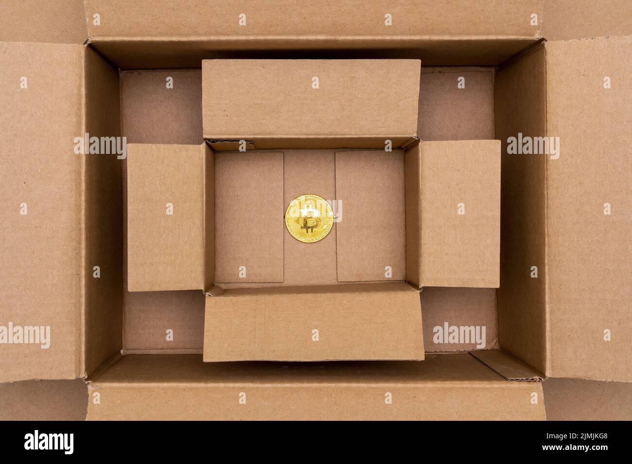Bitcoin coin on the bottom of cardboard box Stock Photo - Alamy