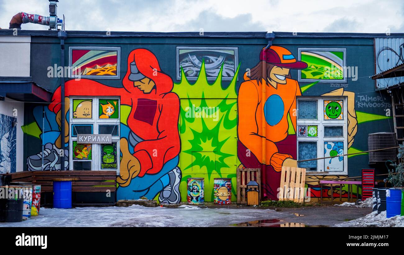 Abstract street art. A bright drawing in the courtyard of a building on ...