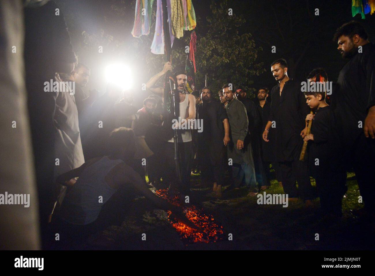 Pakistani Shiite Muslims walk on burning coal during a procession on ...