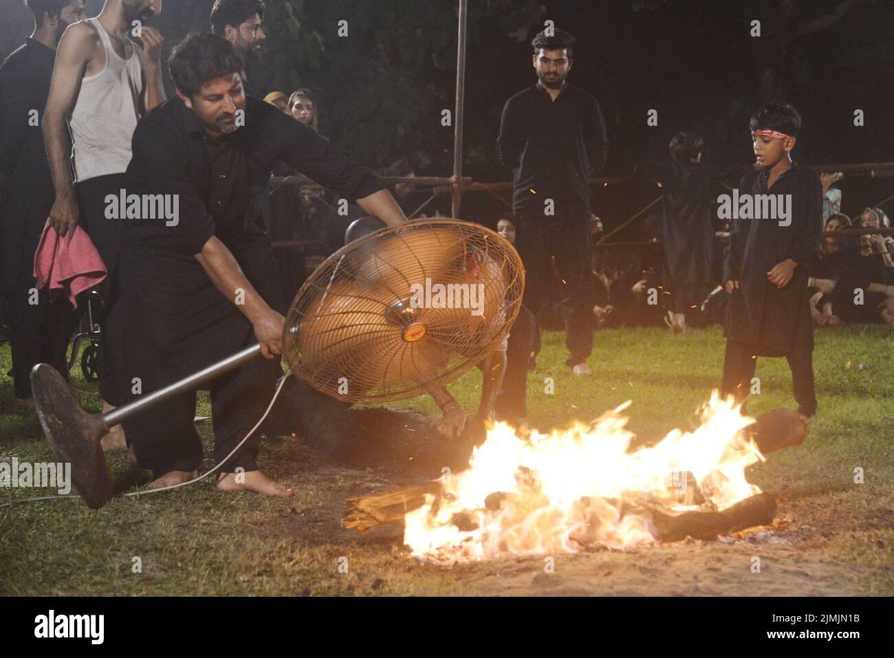 Pakistani Shiite Muslims walk on burning coal during a procession on ...