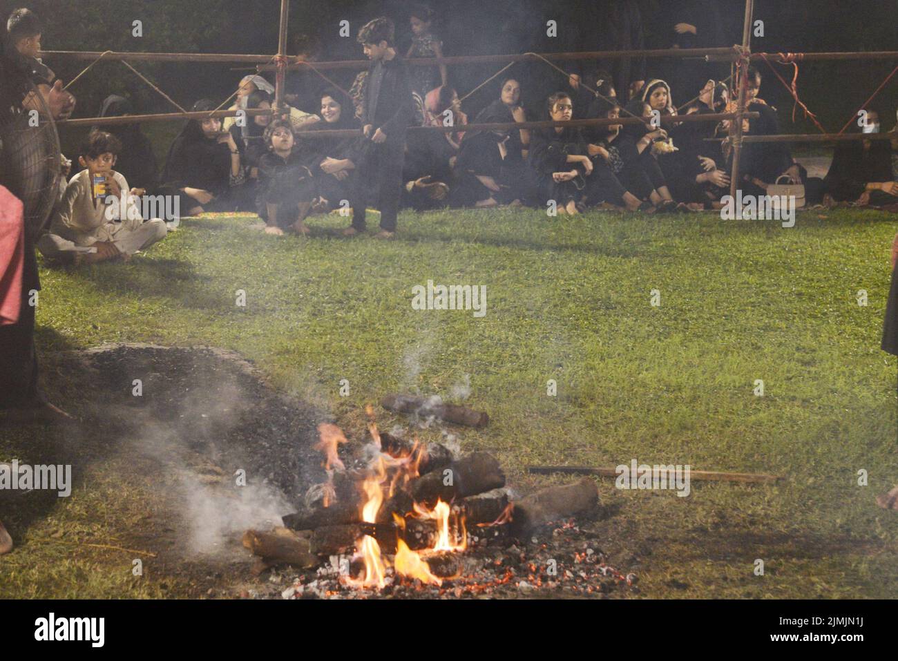 Pakistani Shiite Muslims walk on burning coal during a procession on ...
