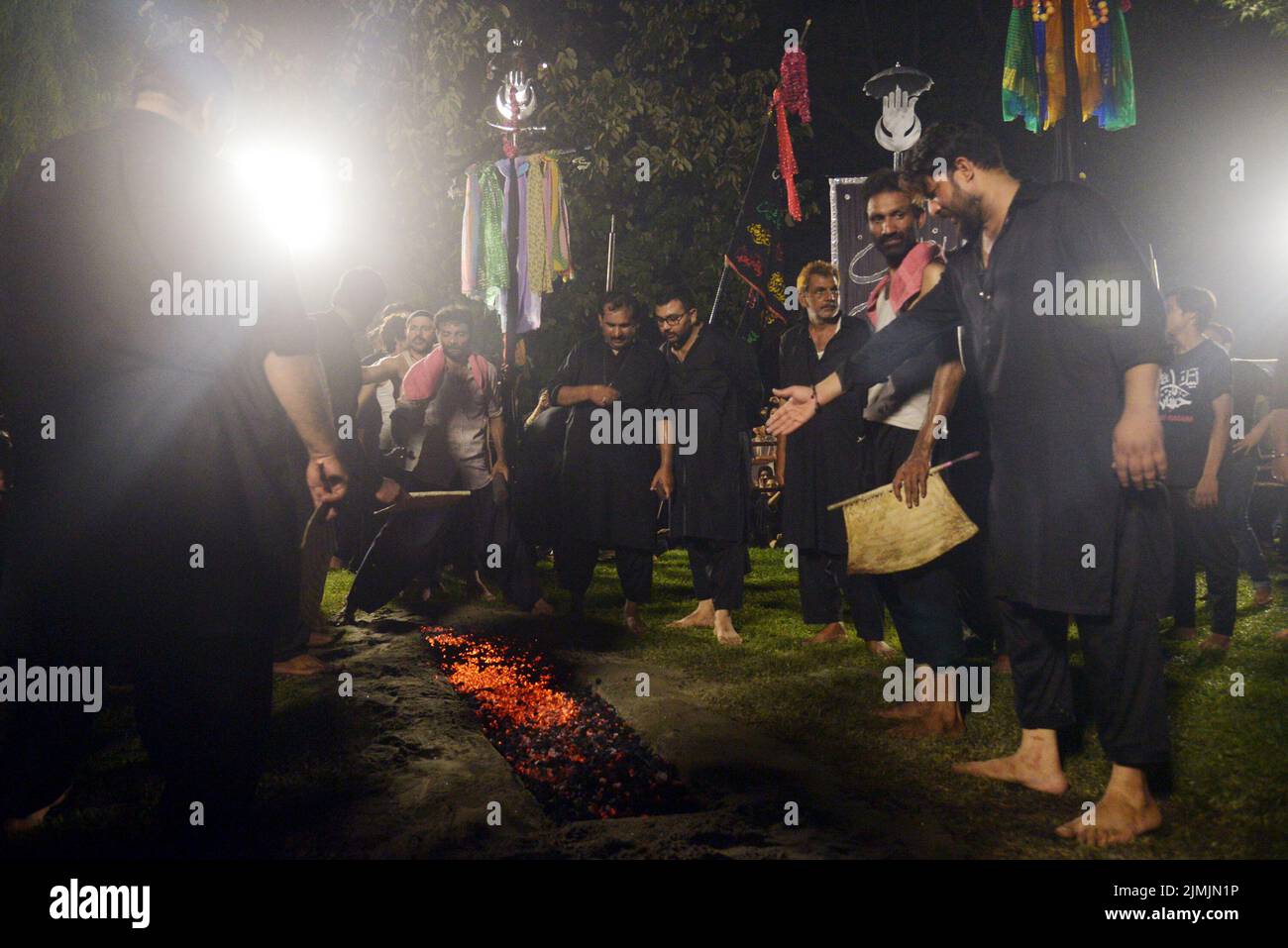 Pakistani Shiite Muslims walk on burning coal during a procession on ...