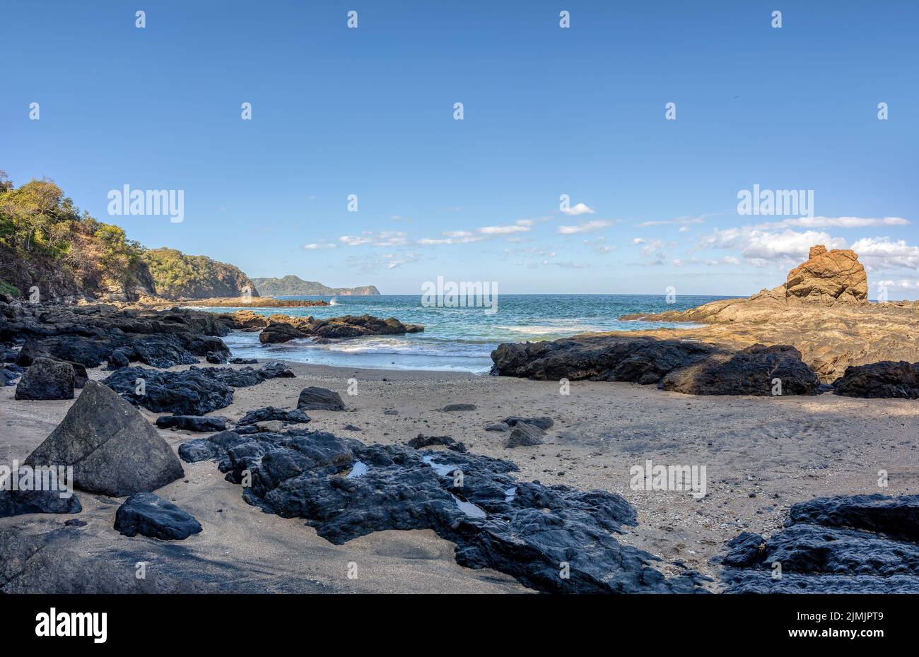 Playa Ocotal and Pacific ocean waves on rocky shore, El Coco Costa Rica ...