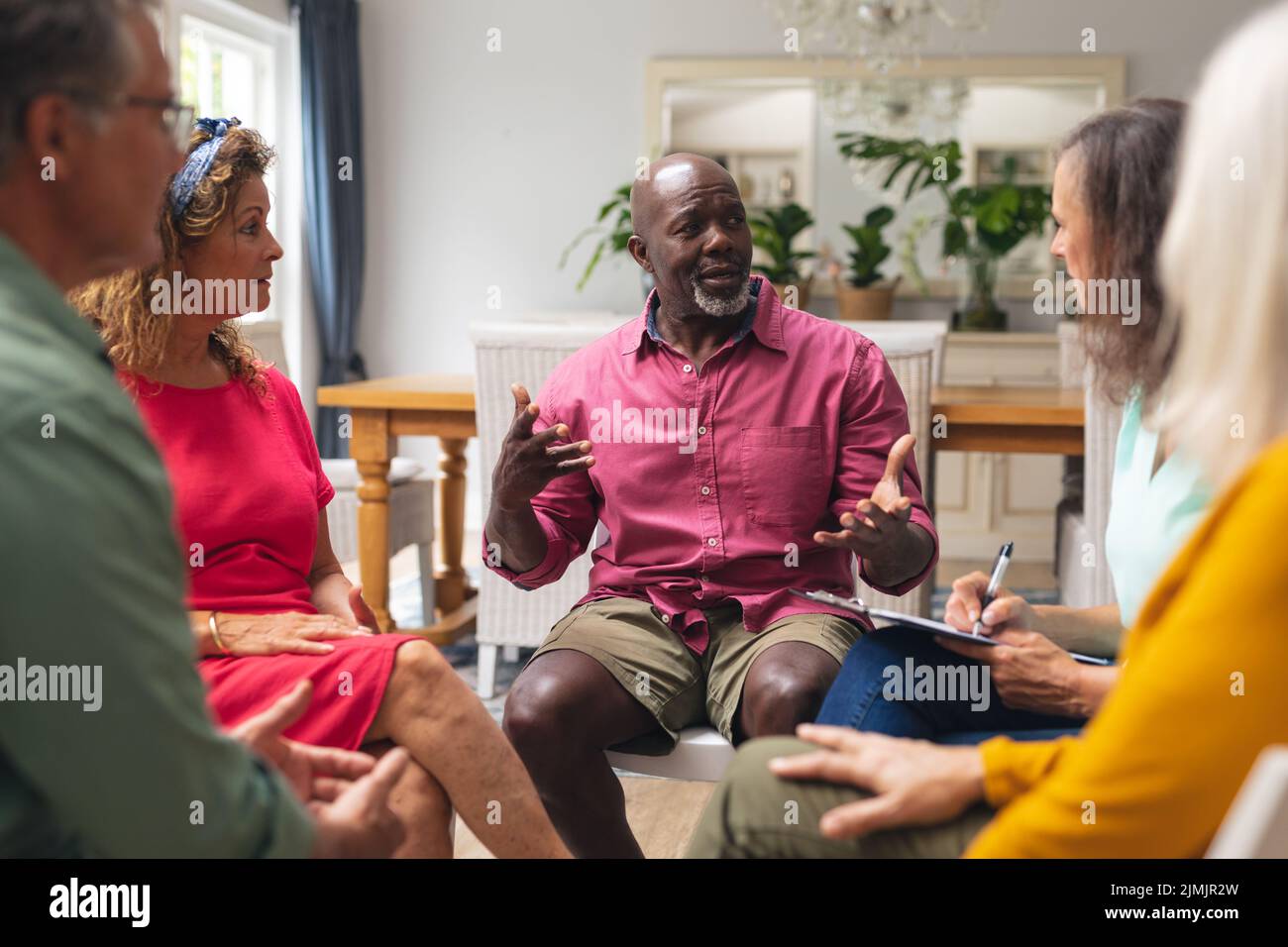 Midsection of multiracial senior males and females discussing during ...