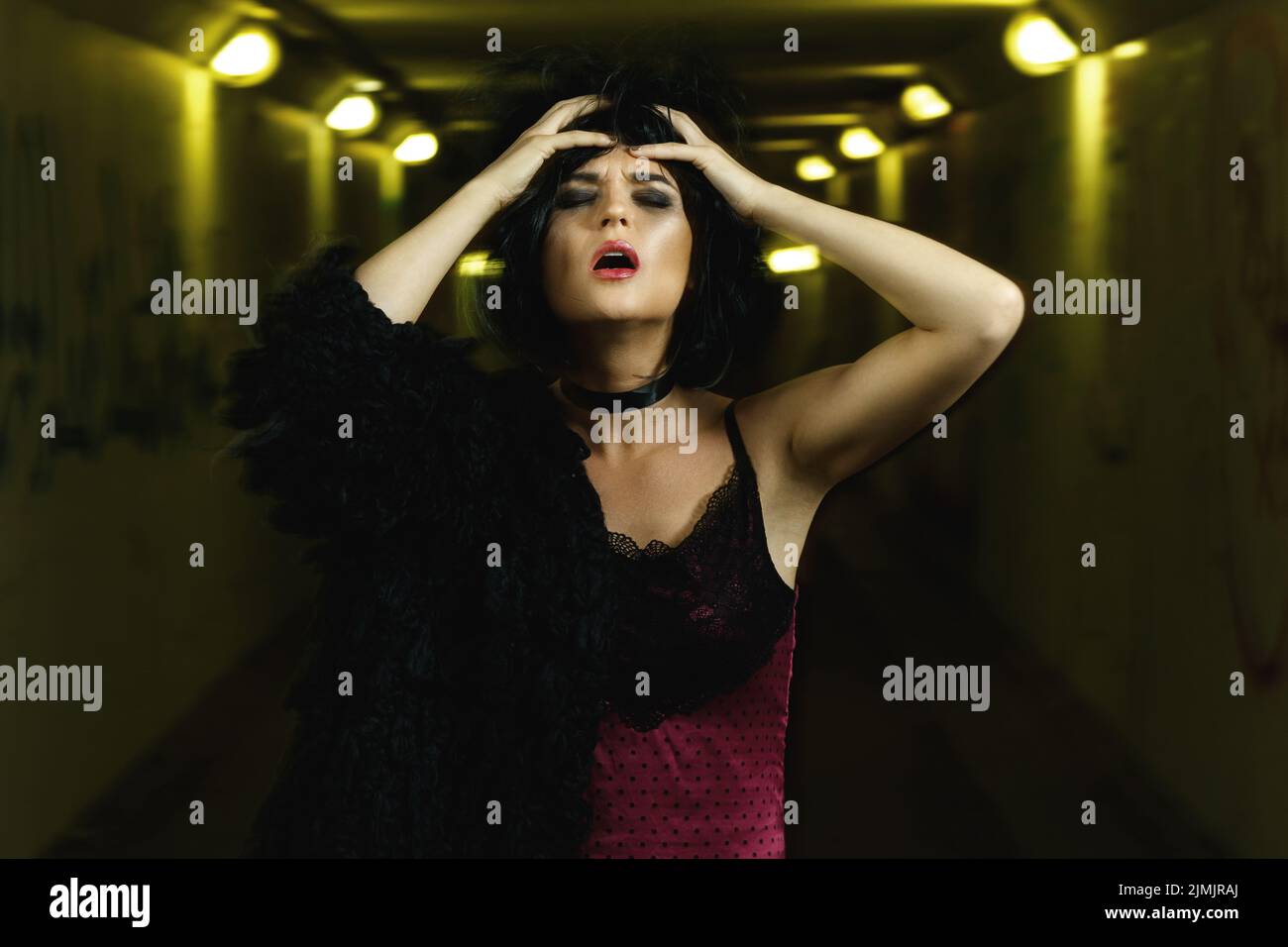 Strange and freaky woman in the dark tunnel Stock Photo - Alamy