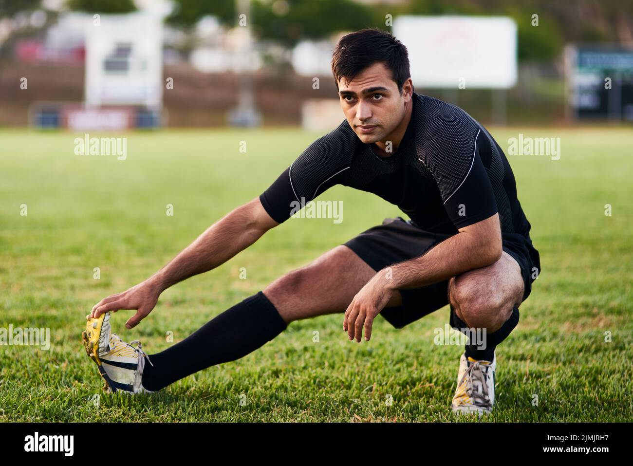 Stretching is key. Full length shot of a handsome young sportsman ...