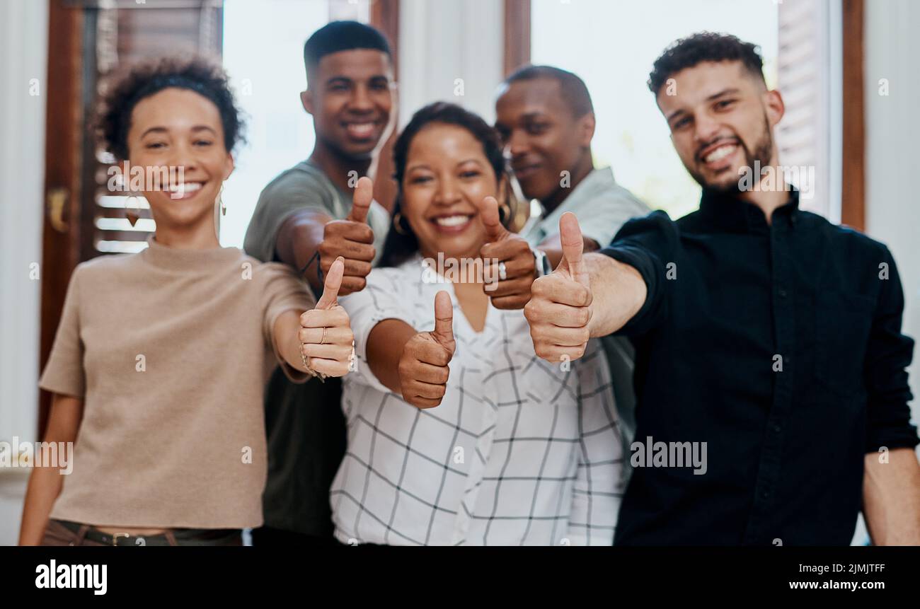 Were super proud of you. a group of young businesspeople showing thumbs ...