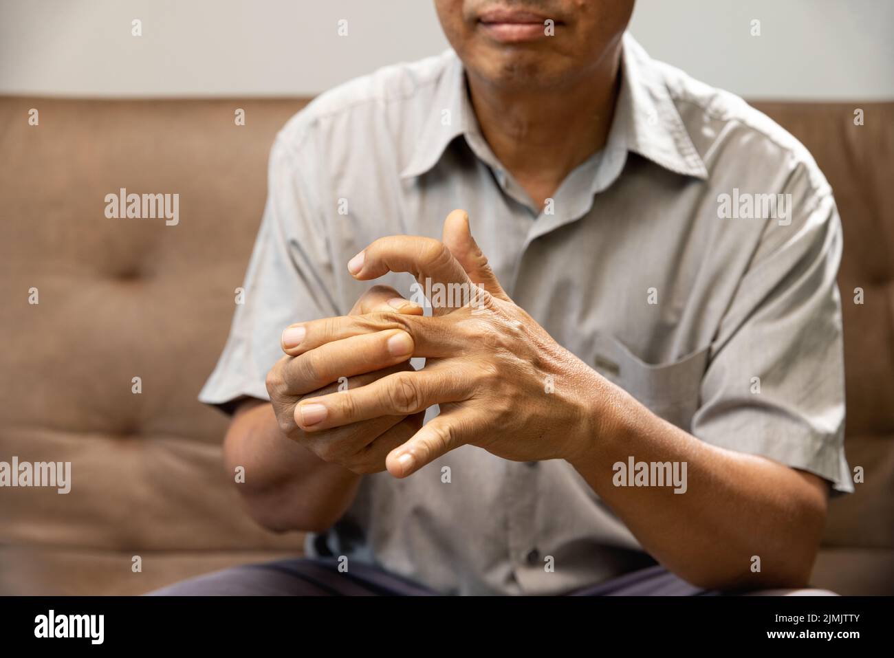 Senior man hand suffering from joint pain with gout inflammation Stock ...