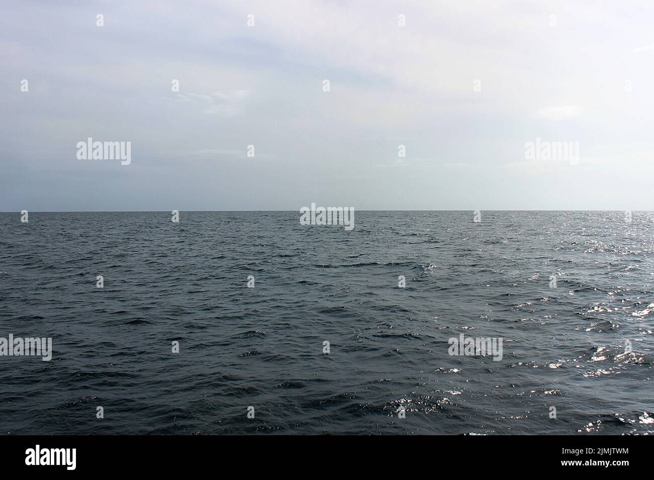 Skyline landscape in open sea and blue sky with some clouds, sailing on ...