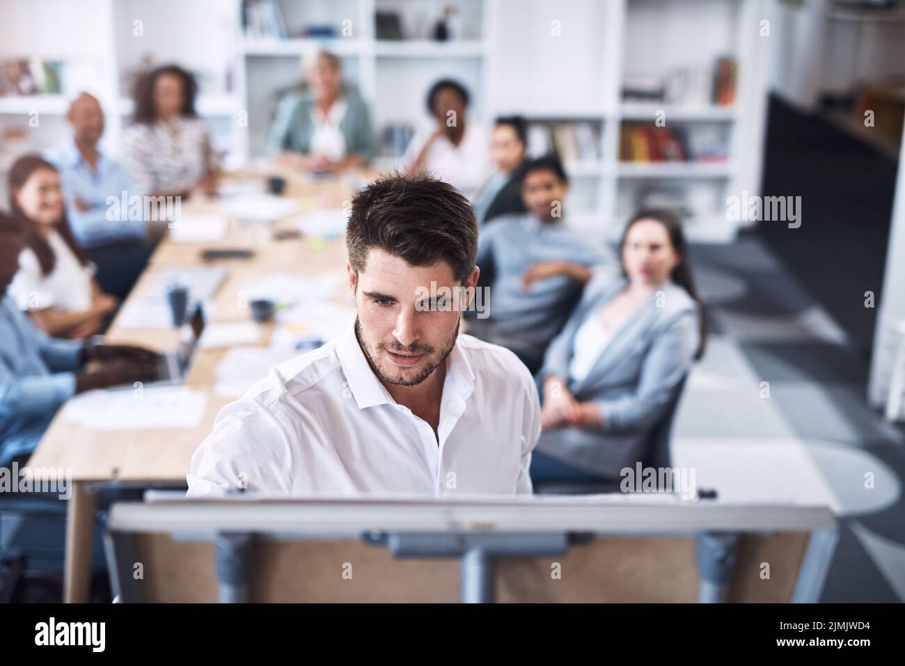 He has the vision and a plan. a young businessman using a whiteboard ...