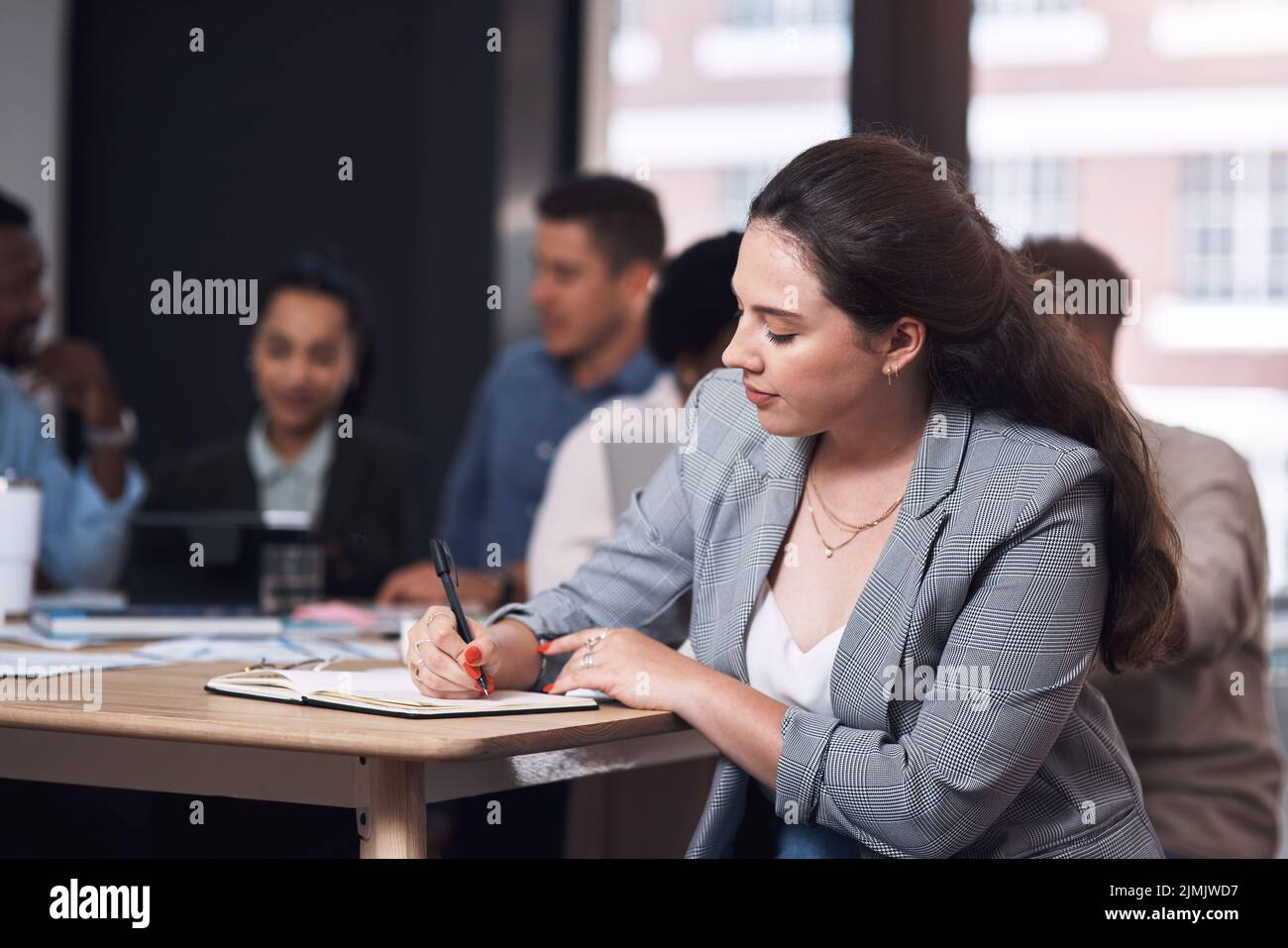 Jotting a few helpful notes for achieving success. a young ...