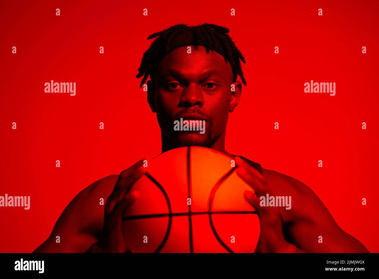 Keep your head in the game. Red filtered shot of a young sportsman ...