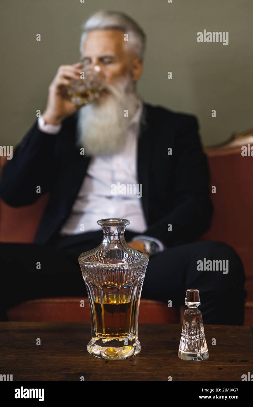 Handsome and bearded senior man drinking whiskey Stock Photo - Alamy