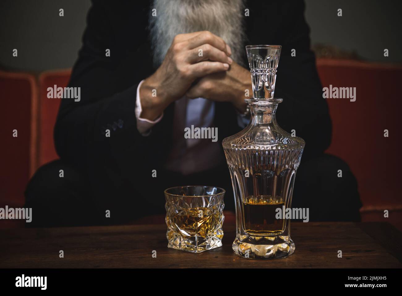Handsome and bearded senior man drinking whiskey Stock Photo - Alamy