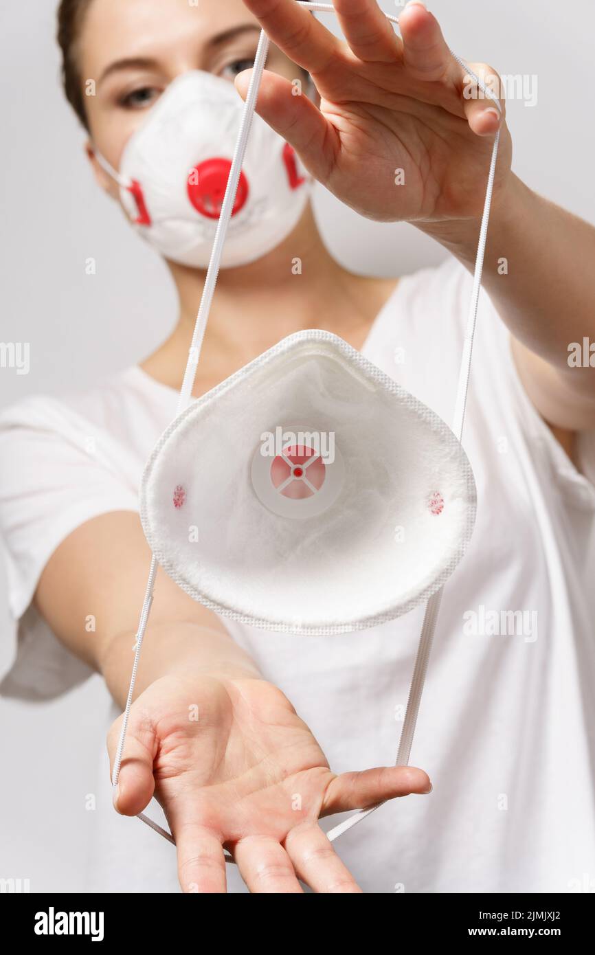 Woman is put on a face mask on someone for protection against virus ...