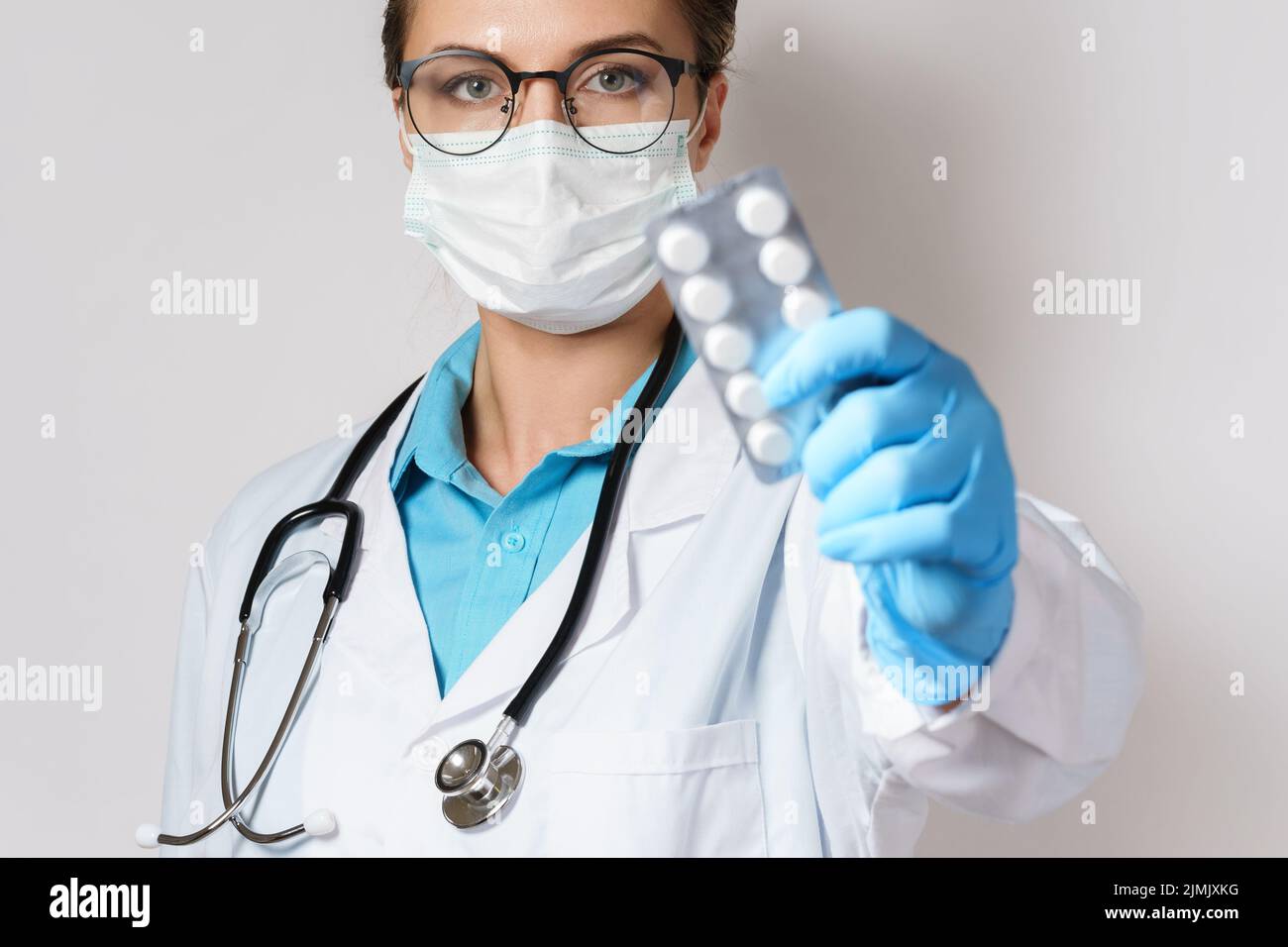 Female doctor and pills in foil packaging Stock Photo - Alamy