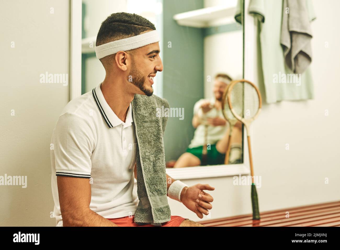 Lounging around in the locker room. two young men chatting in the ...