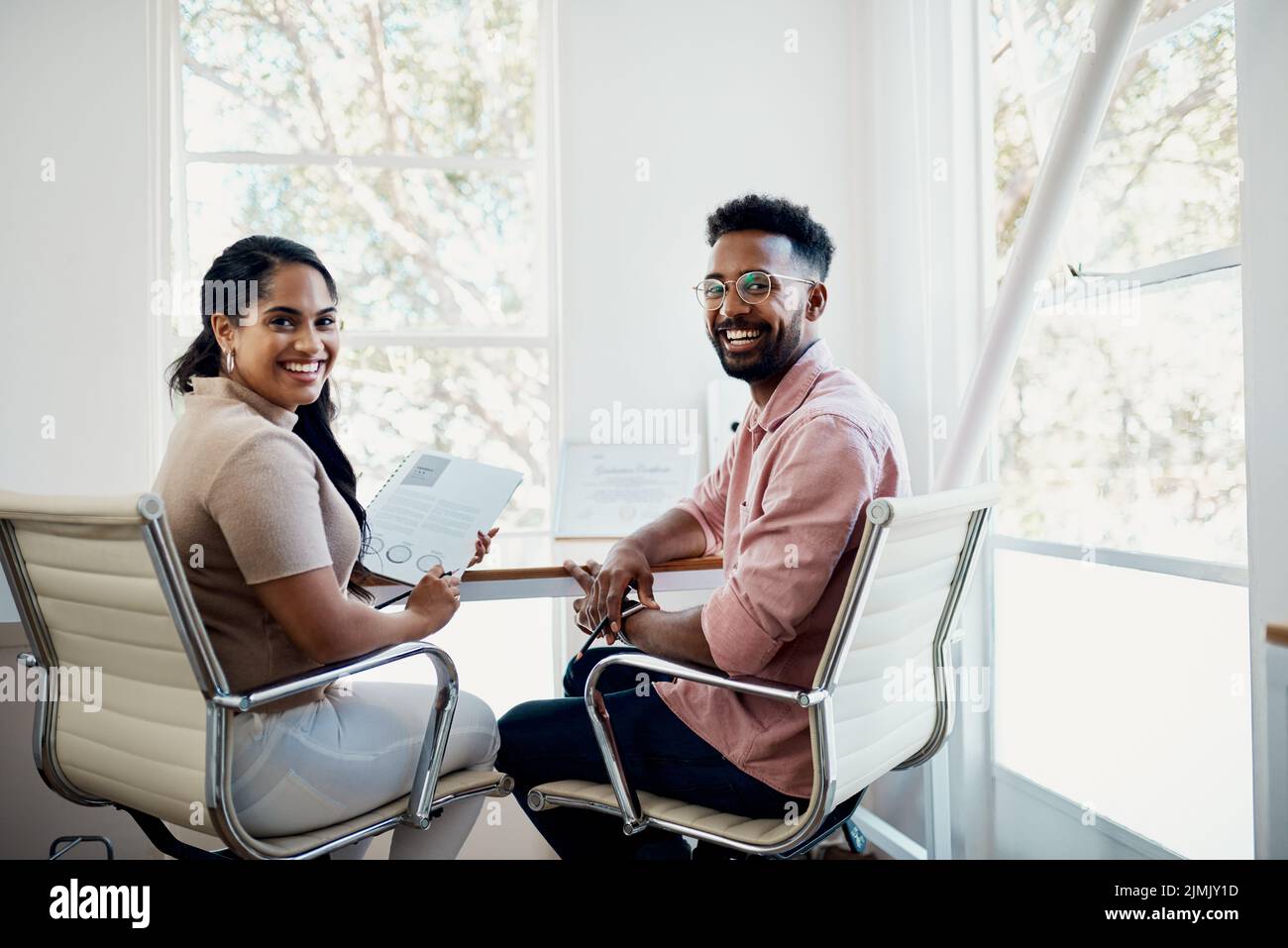 Always working hard. Cropped portrait of two young businesspeople ...
