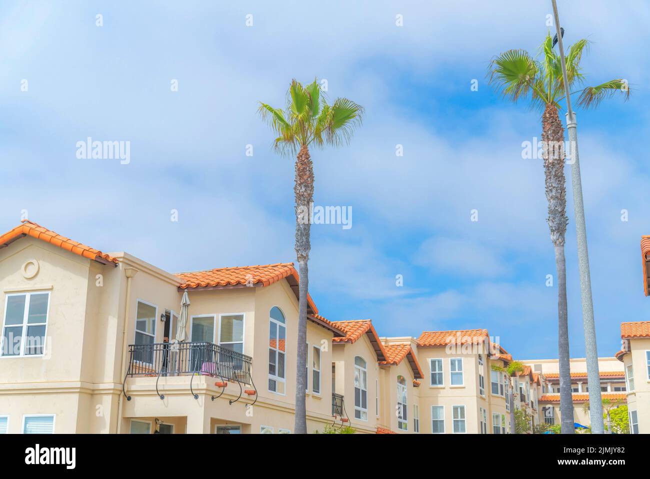 Condos in SoCal. Complex apartment buildings with palm trees outdoors ...