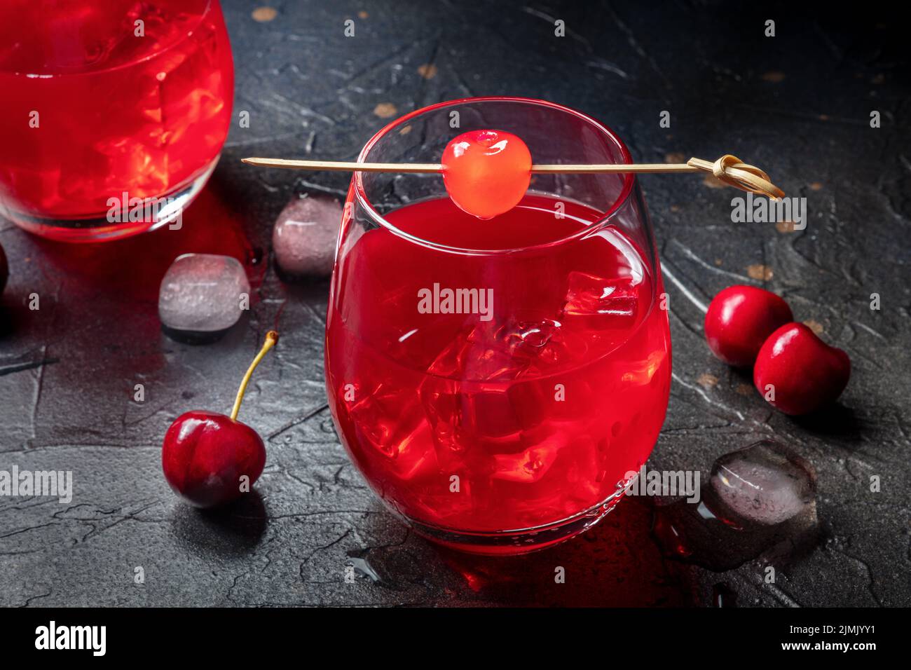 Cocktail cherry and a mocktail on a dark background, a vibrant red ...