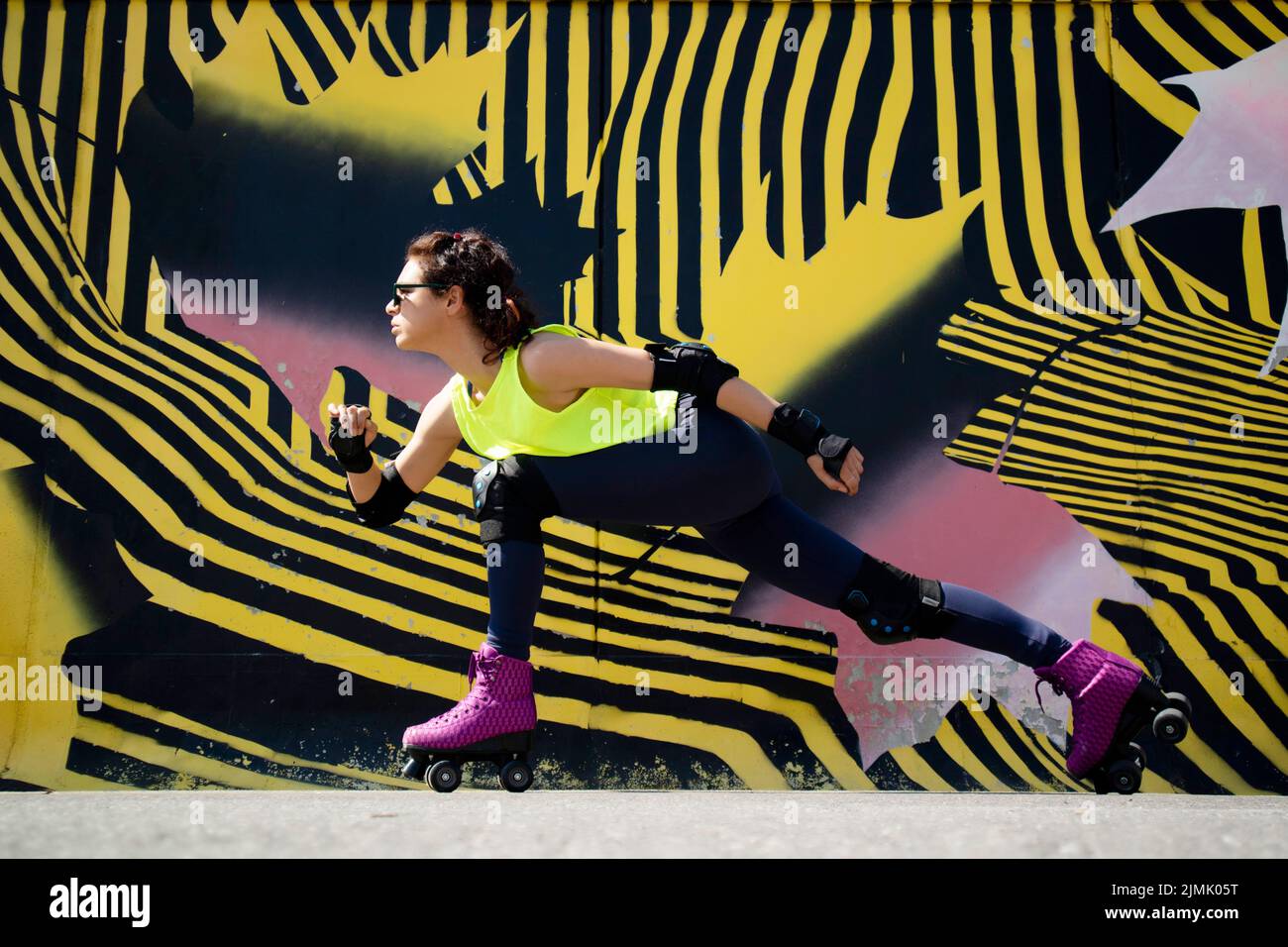 Young girl doing gymnastics with roller skates Stock Photo - Alamy