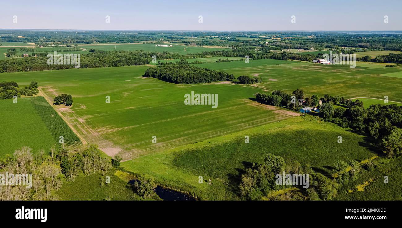 A hot summer day with a clear sky showing rural wisconsin farm fields ...