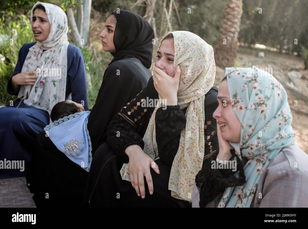 Palestinian women interact at a hospital, after their relative was ...