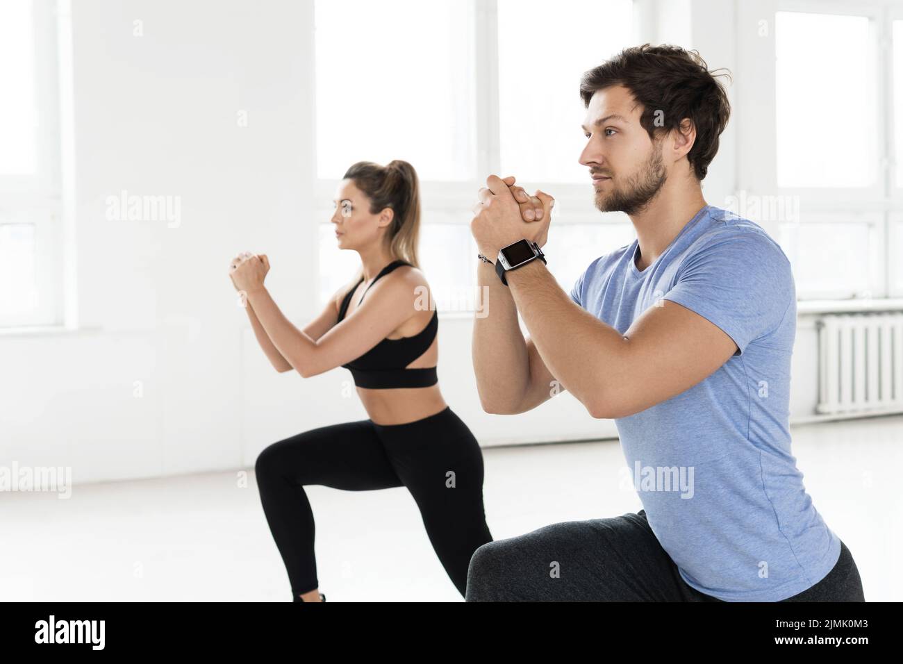 Fitness man and woman during workout with in the gym Stock Photo - Alamy