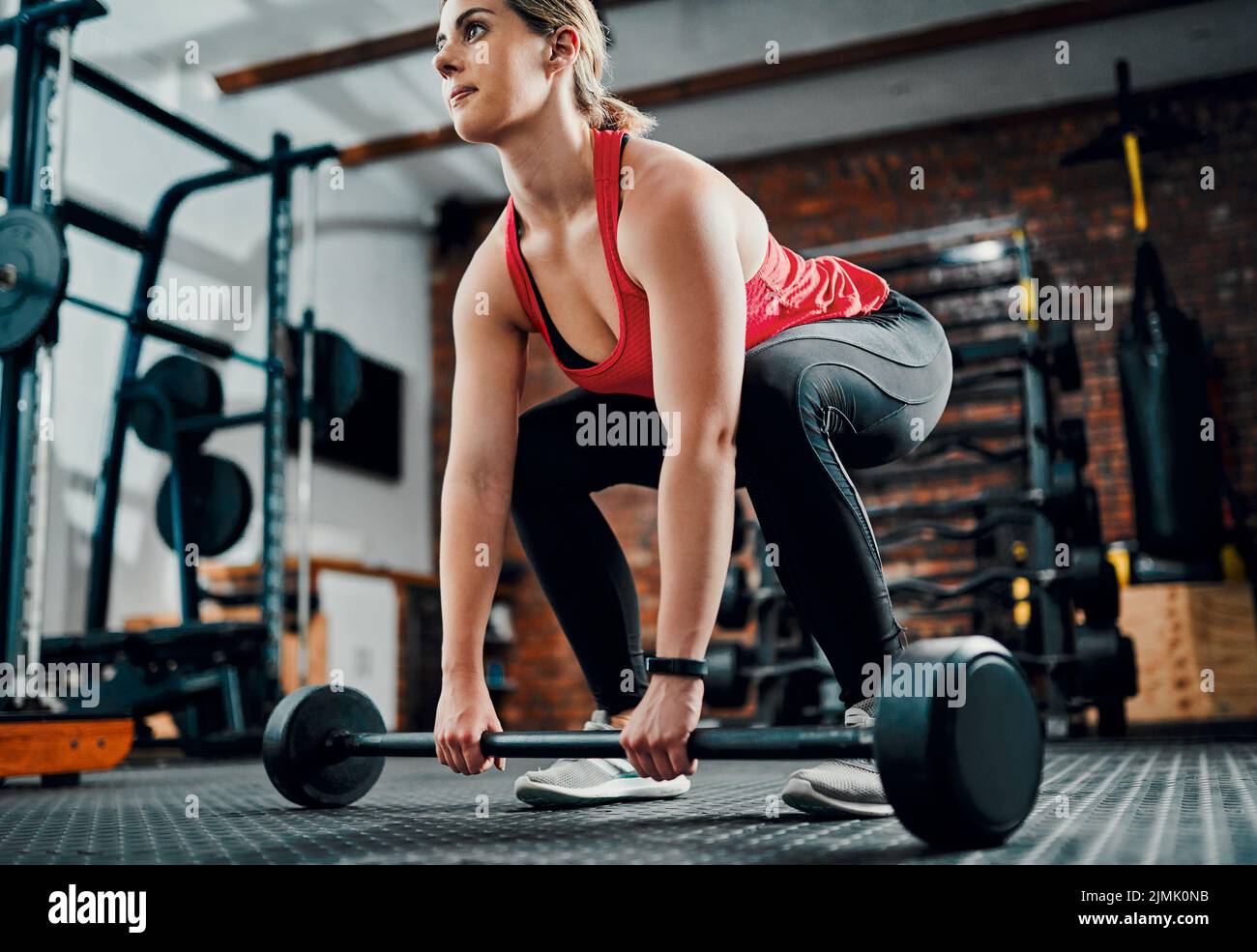 Lift with your legs. Full length shot of an attractive young female athlete working out with ...
