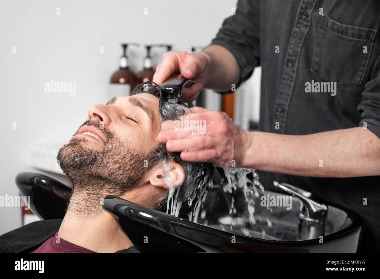 Barber shop hairdresser man washes hi-res stock photography and images ...
